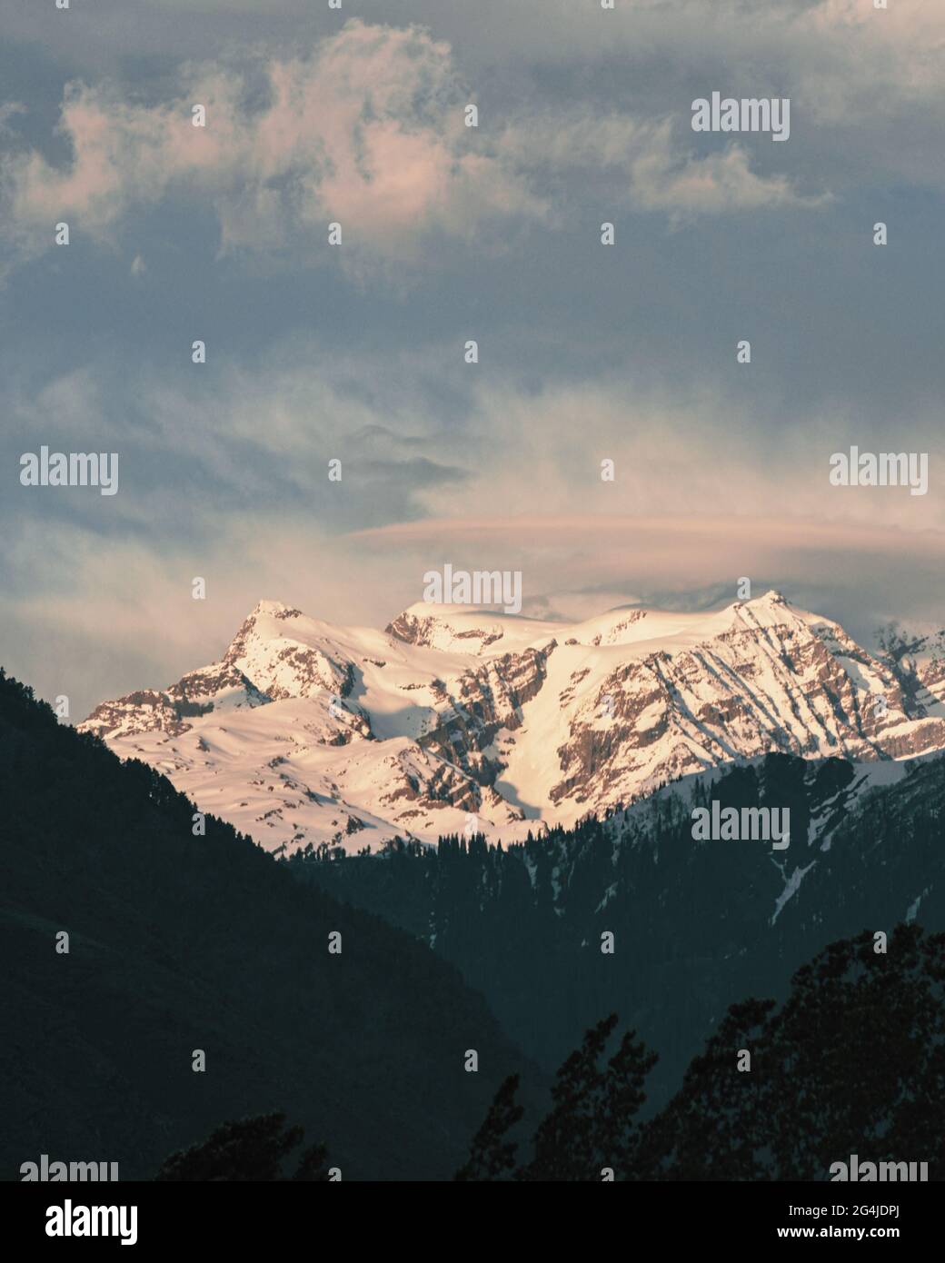 Vertical shot of a snowy mountain on a cloudy day Stock Photo - Alamy