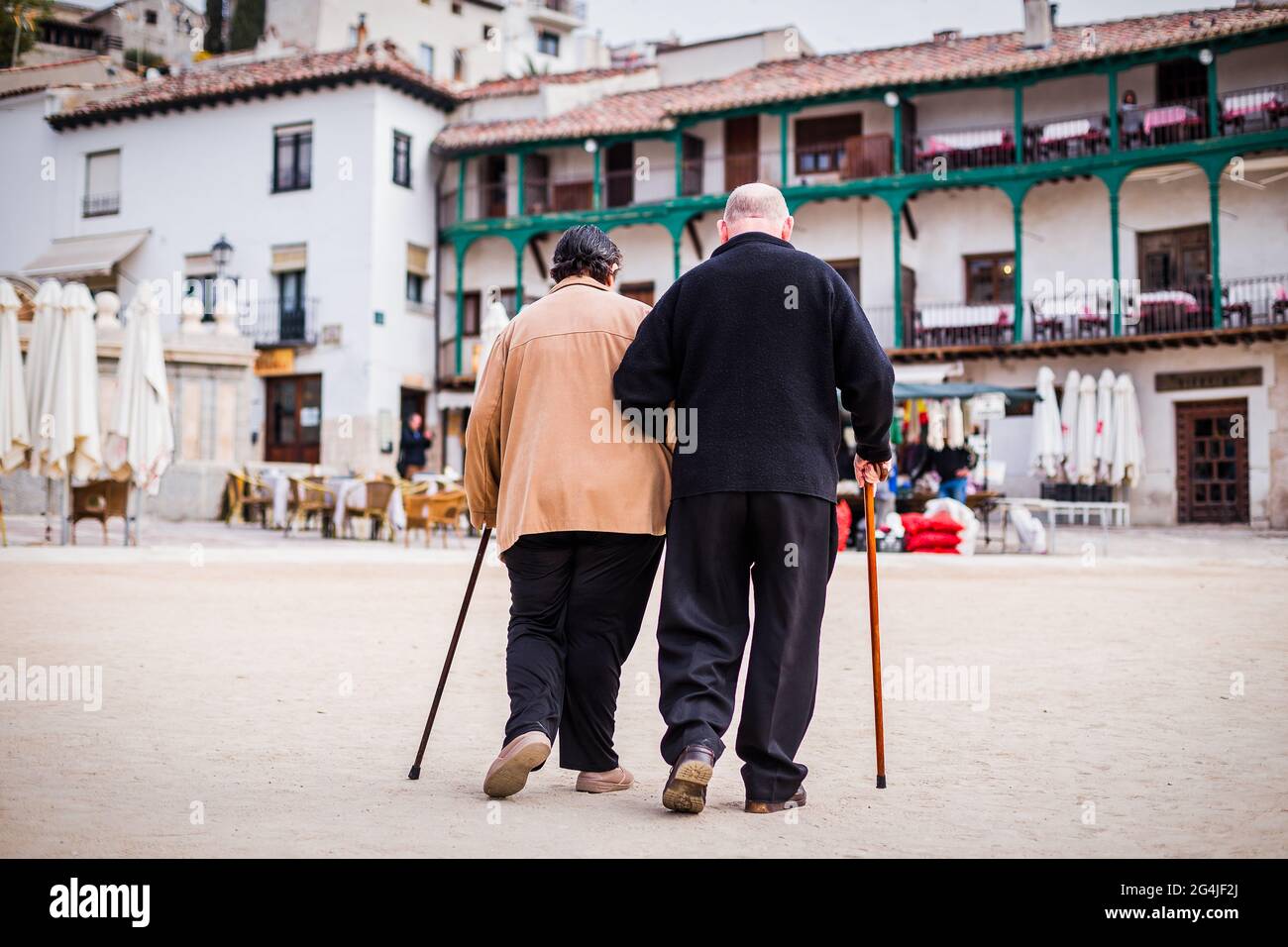 Old pensioner couple walking together. Elderly man and woman travel to ...