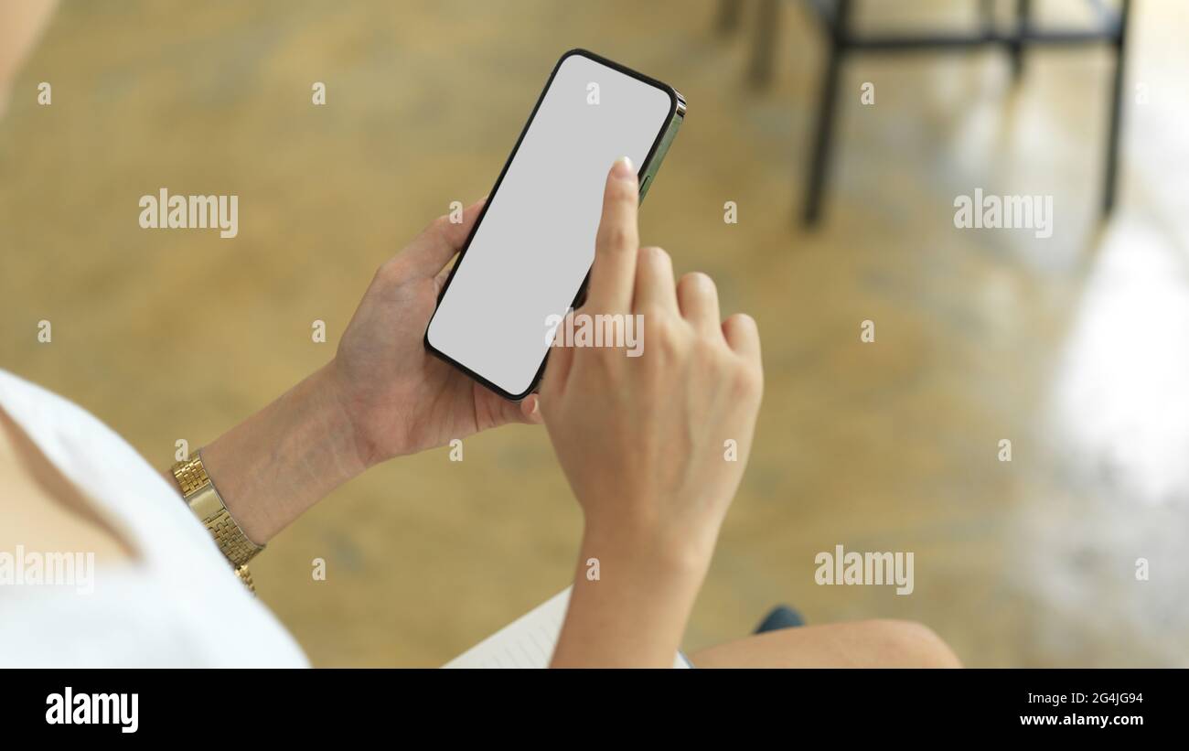 Close up view of female hands using smartphone with mock-up screen in ...