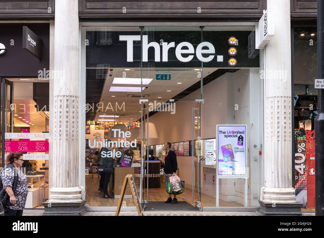 Three logo is seen at one of their stores on Oxford Street in London ...