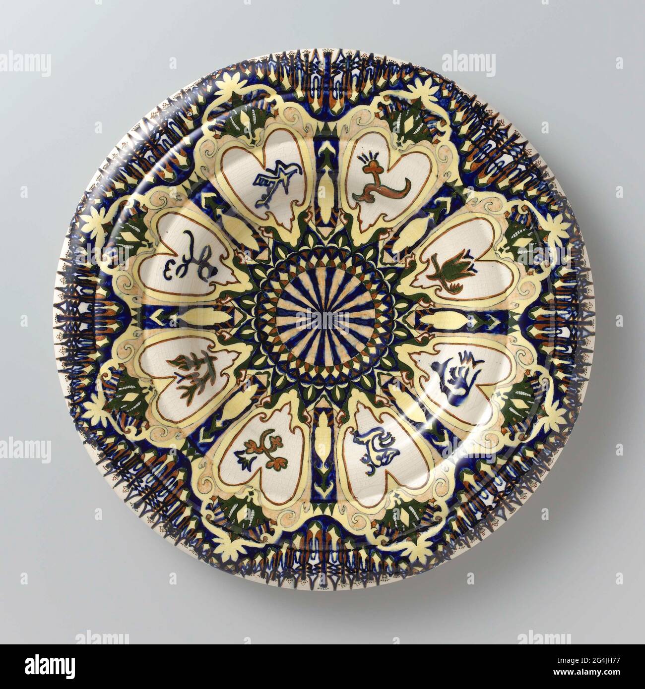 . Pottery wall plate, with ribbed edge and multi-colored painted with ...