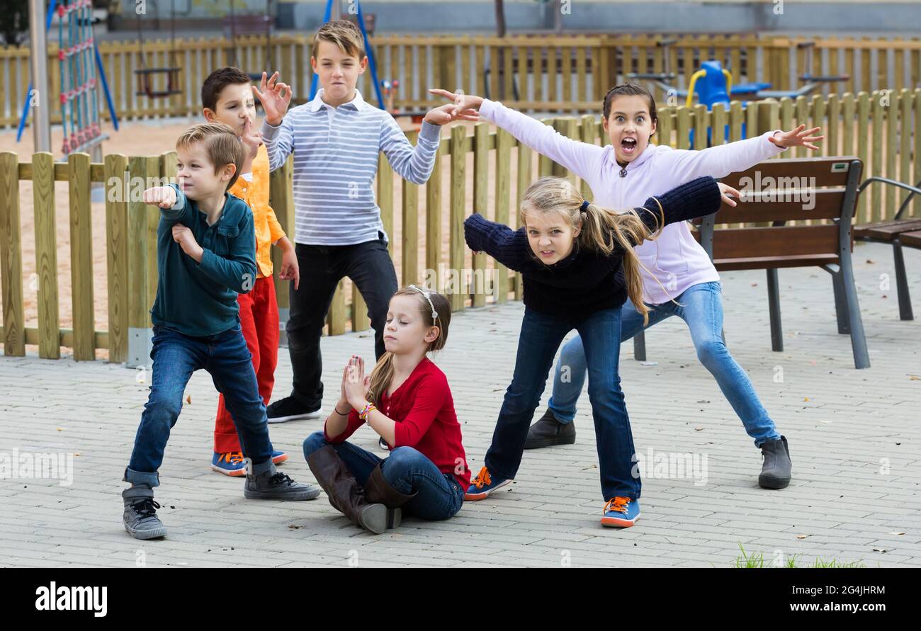 Active kids playing outdoors Stock Photo - Alamy