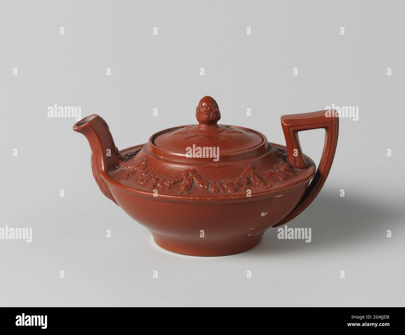 Teapot of red hard-baked pottery, children's toys .. lying elliptical ...