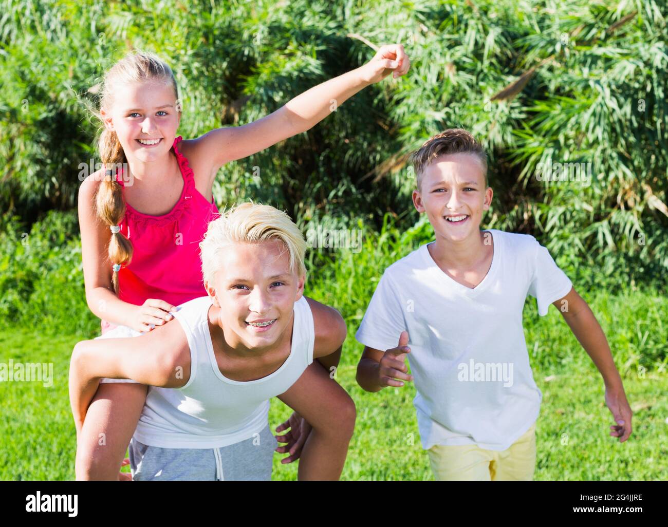 Happy children running together outdoors Stock Photo - Alamy