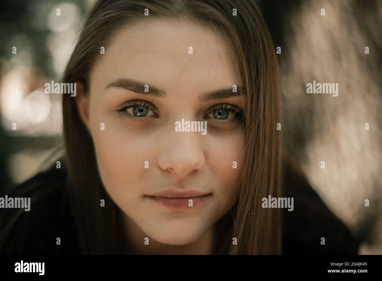 Portrait of a young Caucasian female with a slight smile on her face ...