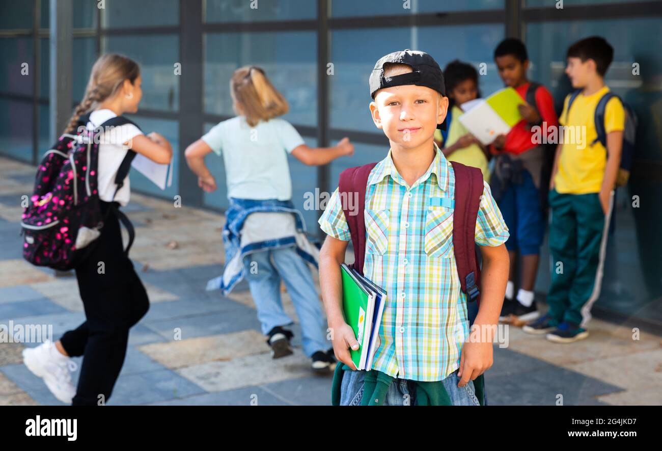 Smiling primary school boy standing outdoors Stock Photo - Alamy
