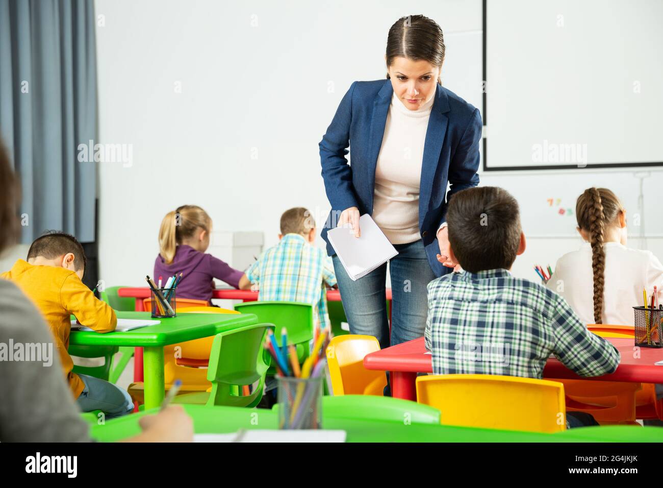 Teacher at lesson with school kids Stock Photo - Alamy