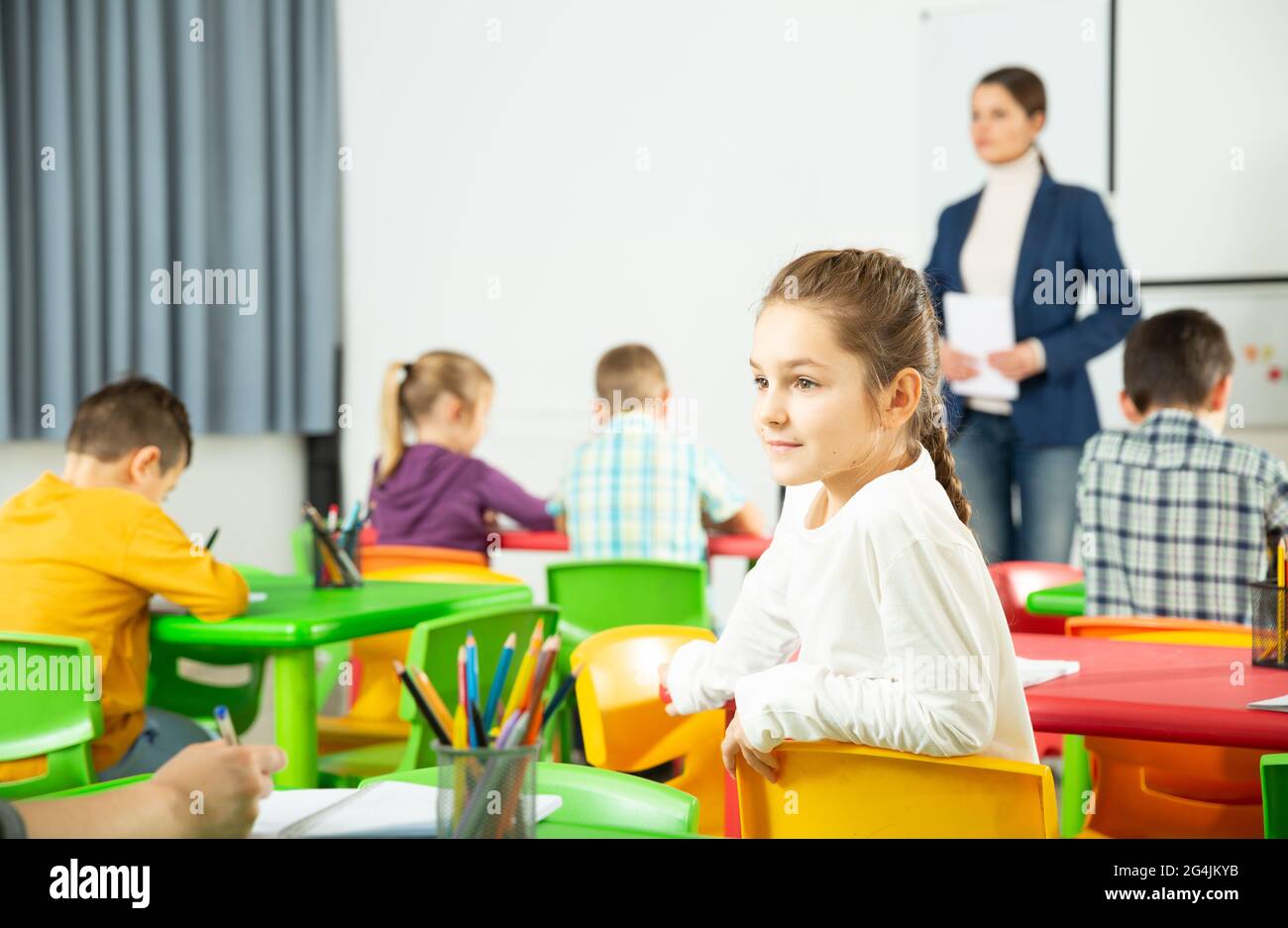 Intelligent girl at school desk Stock Photo - Alamy