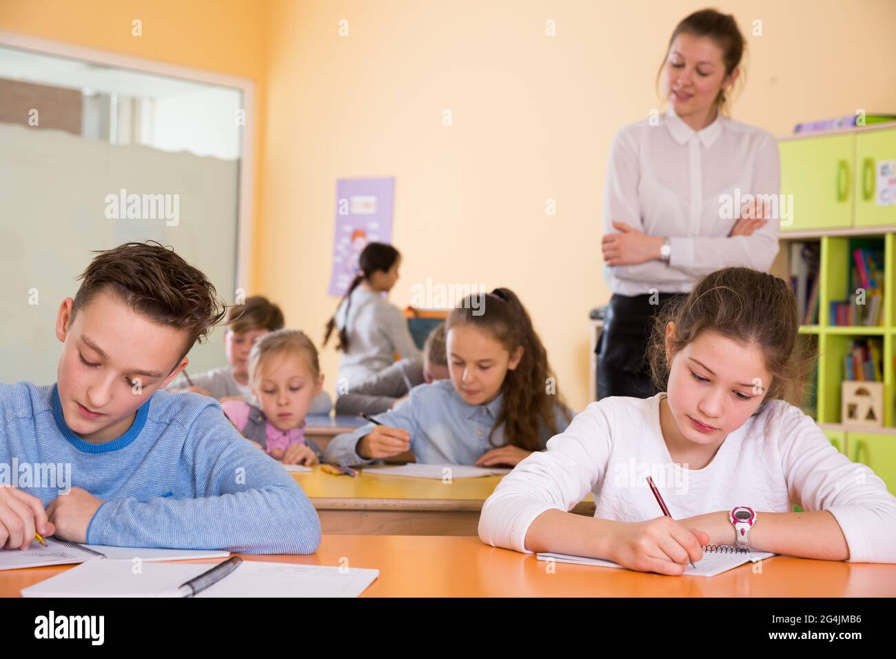 Teacher helping boy exercise hi-res stock photography and images - Alamy