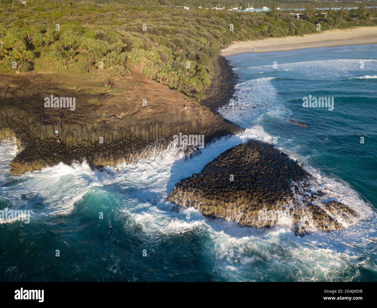 Fingal Head lighthouse and volcanic hexagonal columns of rock off the ...