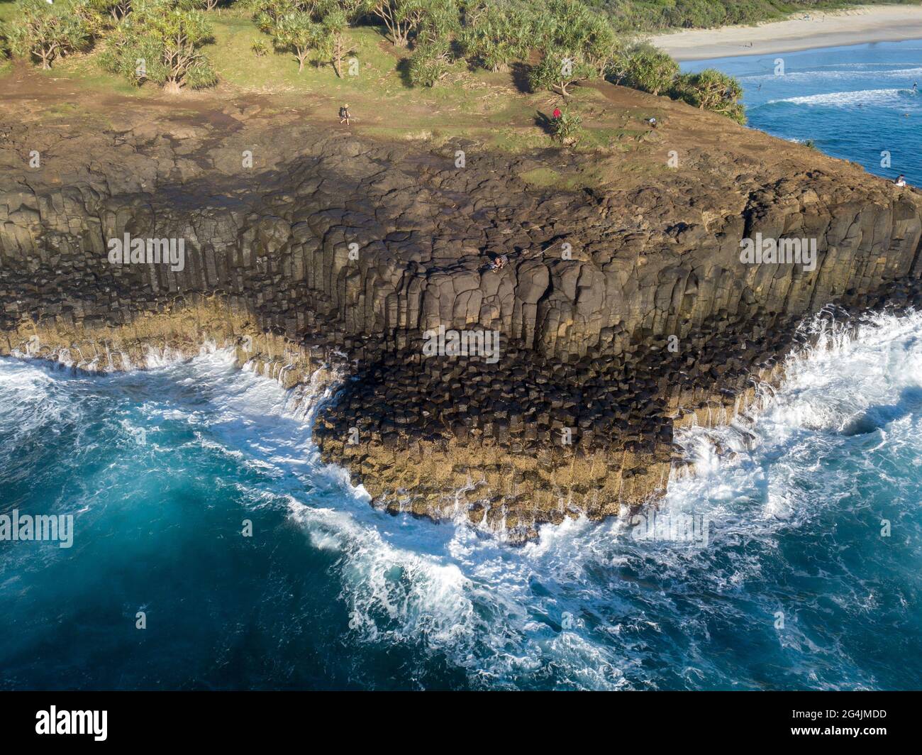 Fingal Head lighthouse and volcanic hexagonal columns of rock off the ...