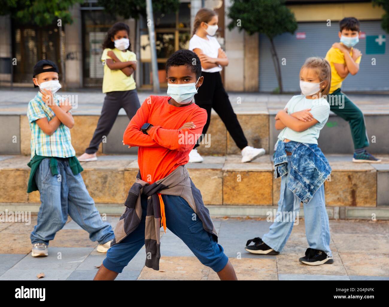 Kids in masks dancing on street Stock Photo - Alamy
