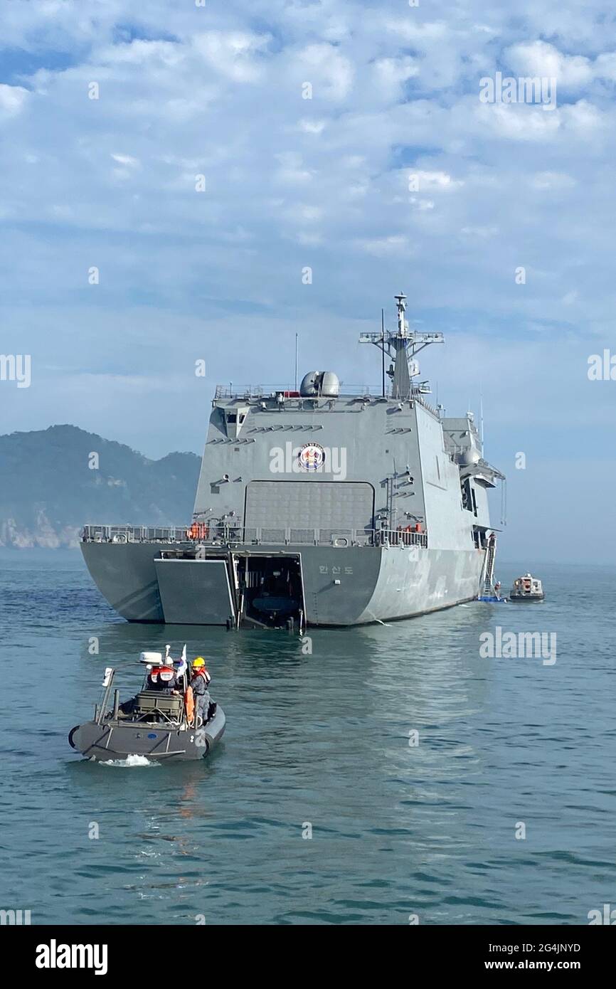 Vaccination center on naval vessel A high-speed boat carrying an island ...