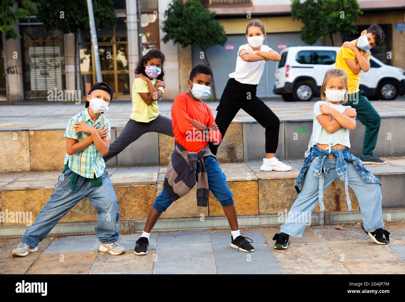 Tweens in protective masks dancing hip-hop on summer street Stock Photo ...