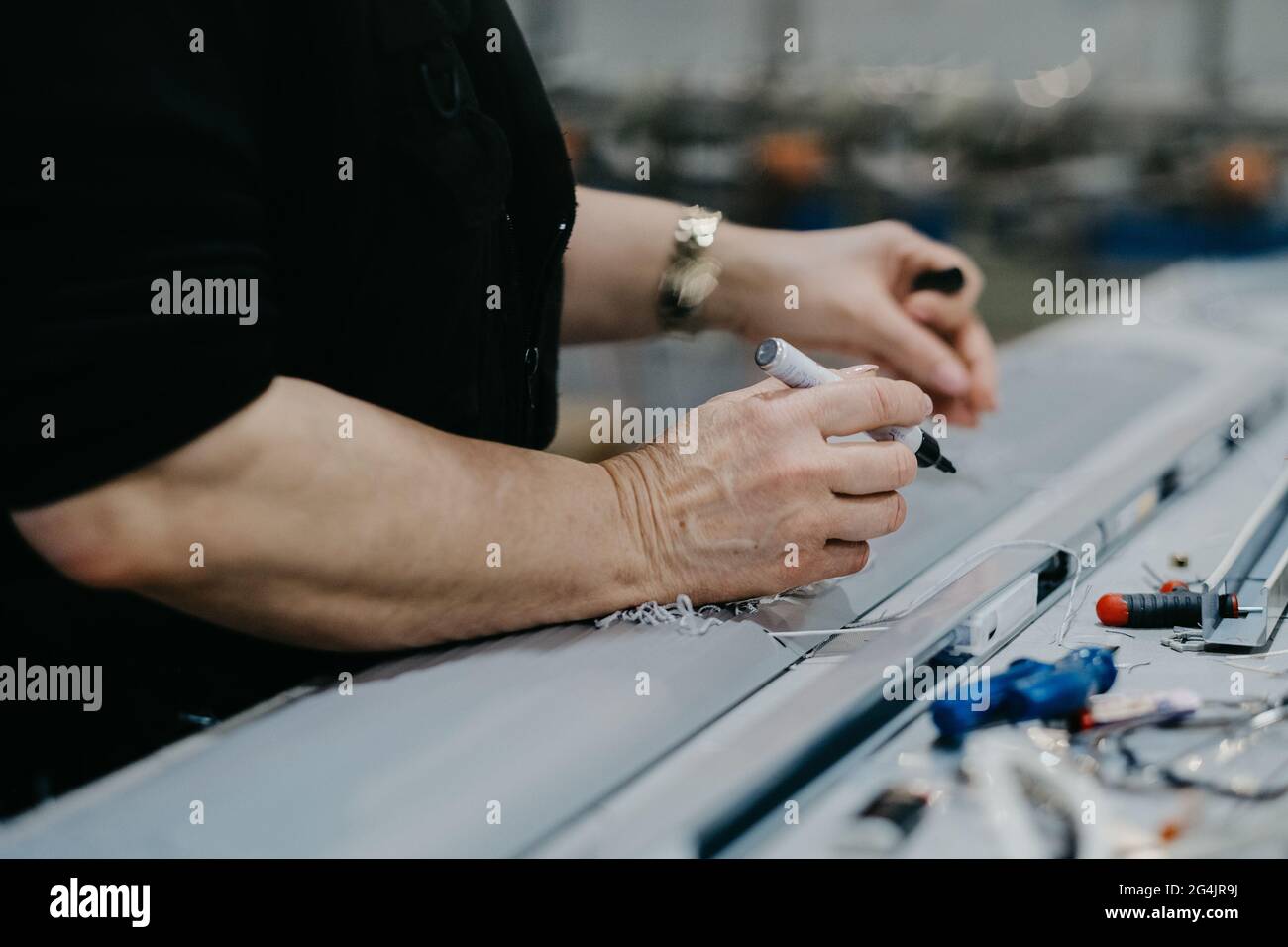 Person working with machine tools in a factory Stock Photo - Alamy