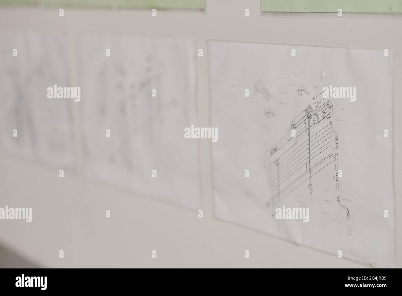 Closeup shot of the blueprints of a mechanism hung on the wall Stock ...