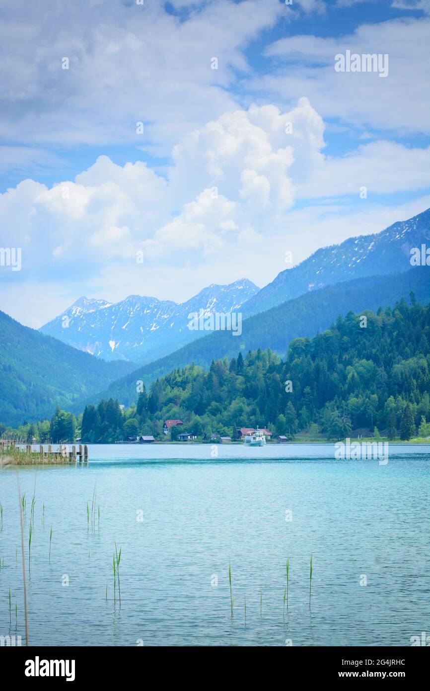 View of Lake Weissensee and mountains in the distance in cloudy weather ...