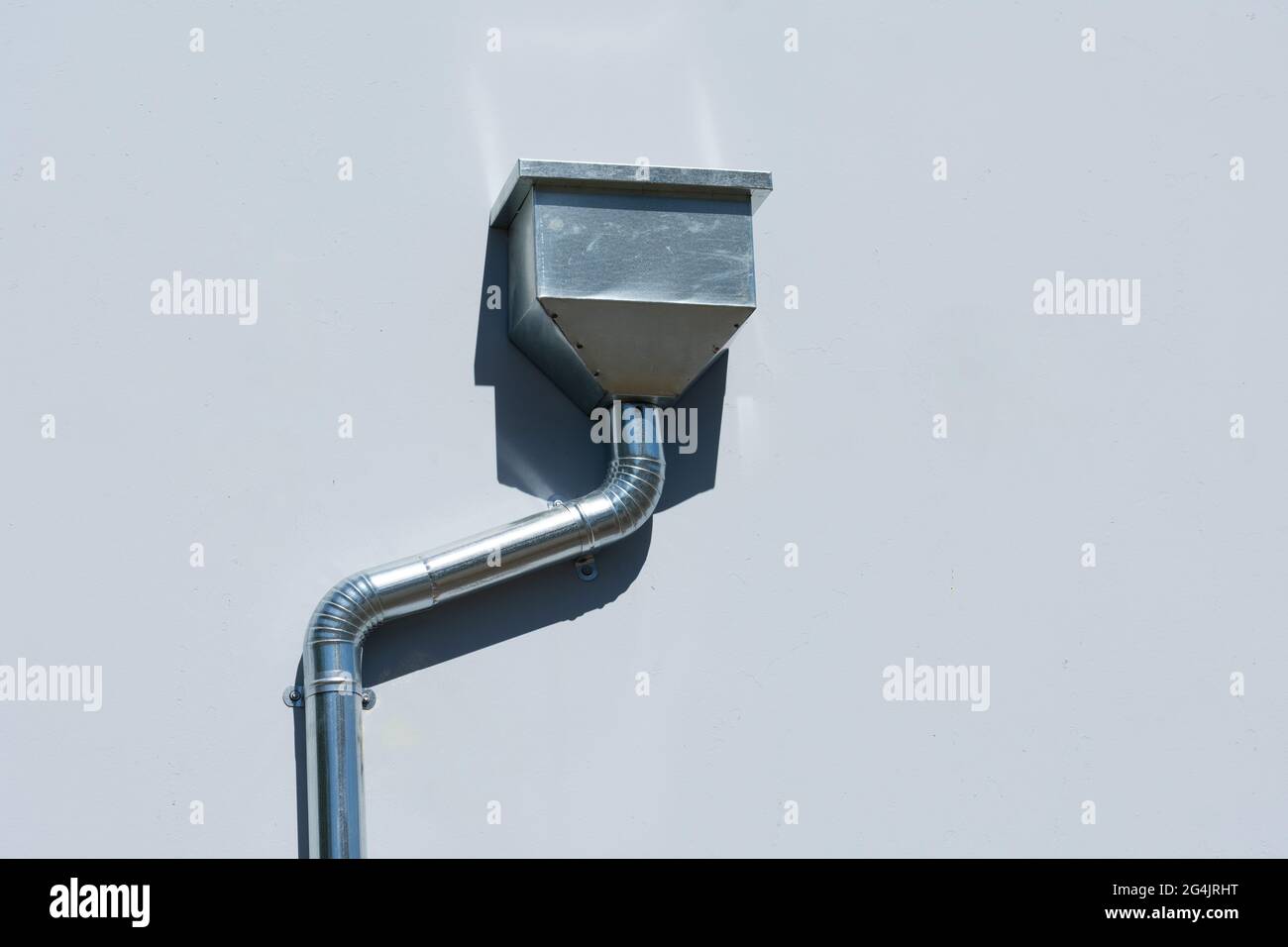 New galvanized rainwater conductor head and bended downspout installed ...