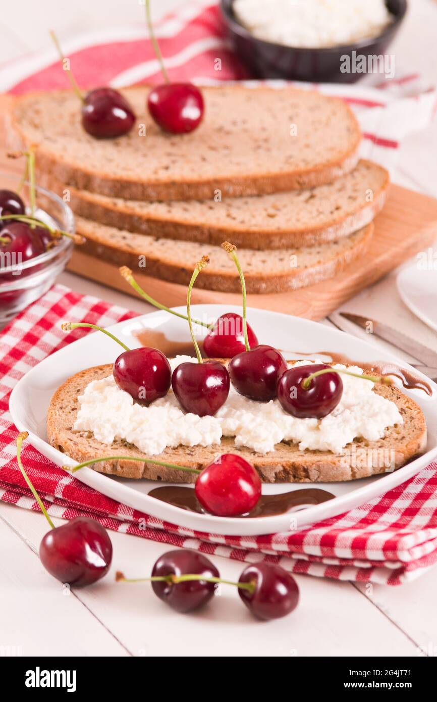 Rye bread with cottage cheese and cherries Stock Photo - Alamy