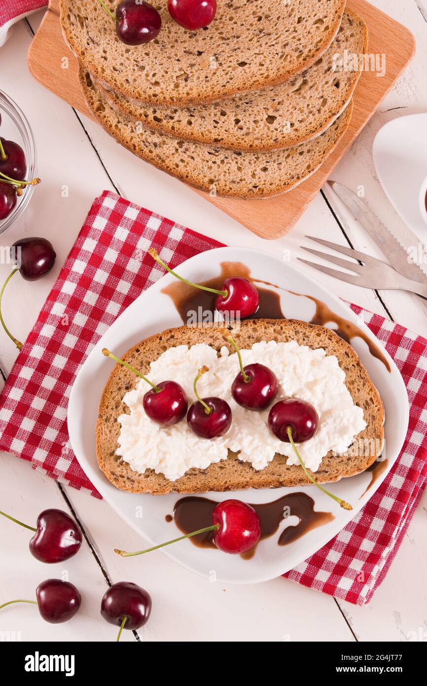 Rye bread with cottage cheese and cherries Stock Photo - Alamy