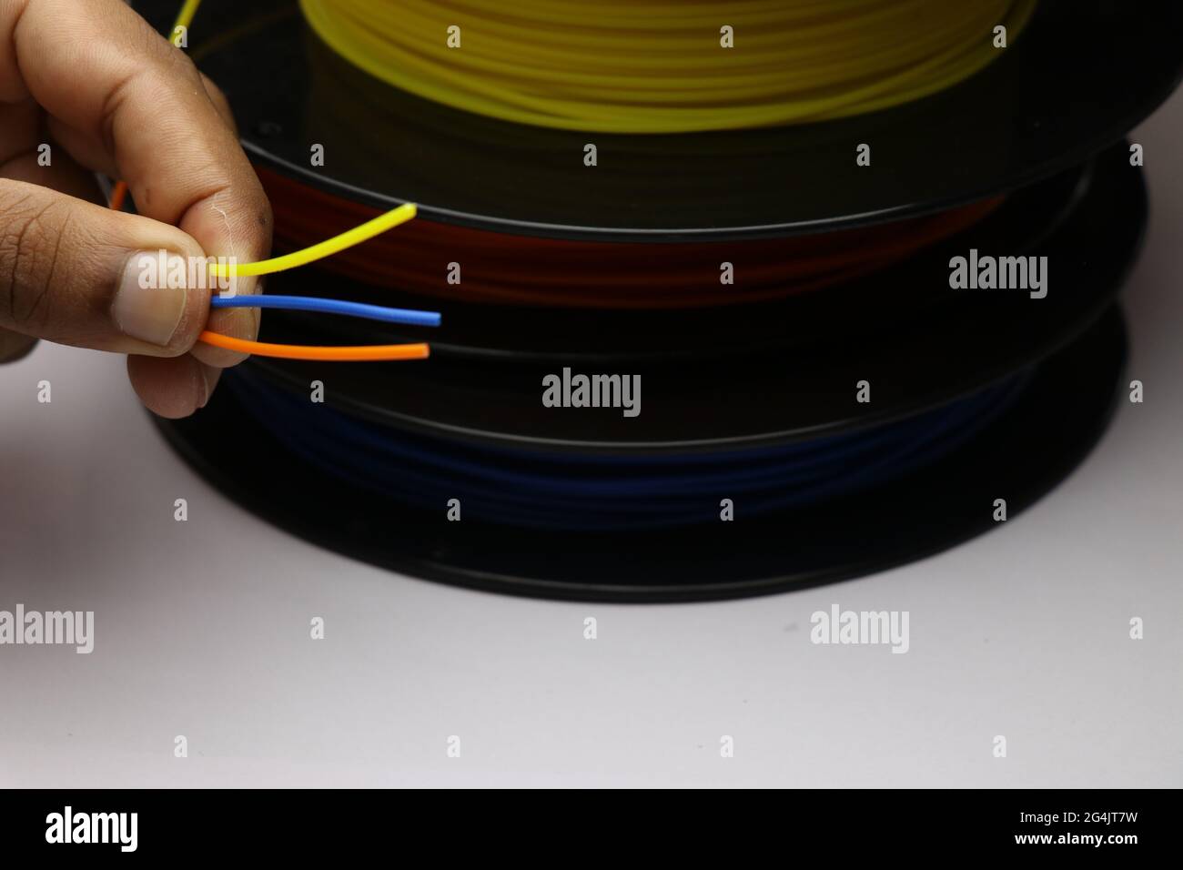 Printer Filaments spool laid horizontally with three different color ...