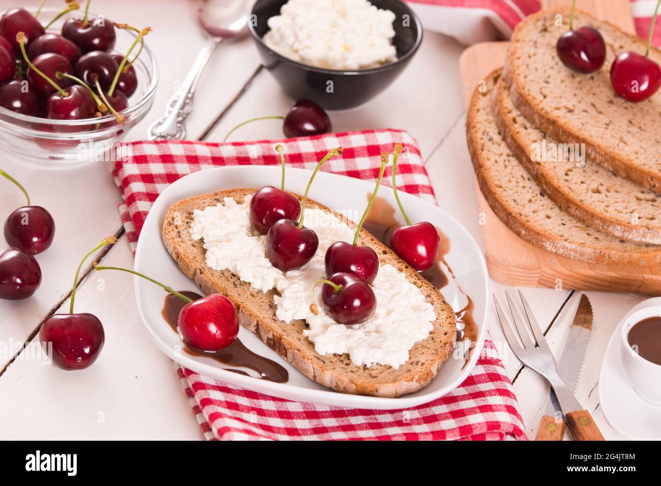 Rye bread with cottage cheese and cherries Stock Photo - Alamy