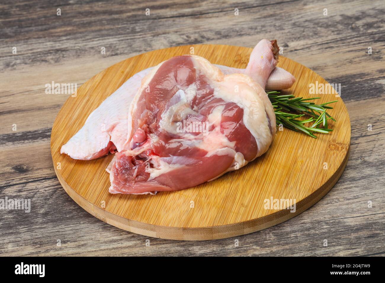 Raw duck leg served rosemary for cooking Stock Photo - Alamy