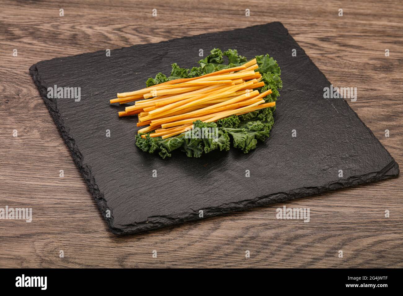 Caucasian Chechel cheese sticks over board Stock Photo - Alamy