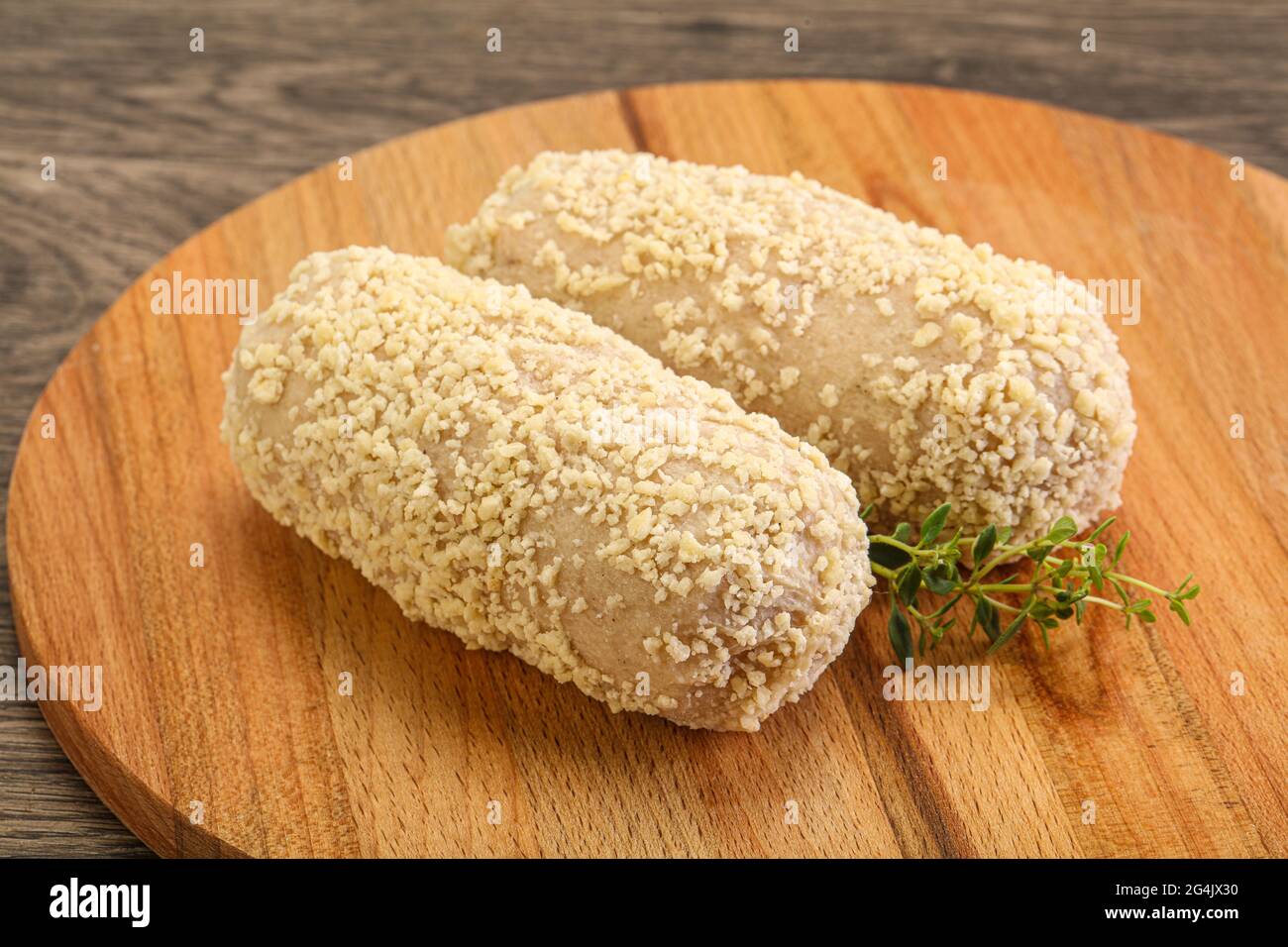 Raw breaded chicken cutlet for roast Stock Photo - Alamy