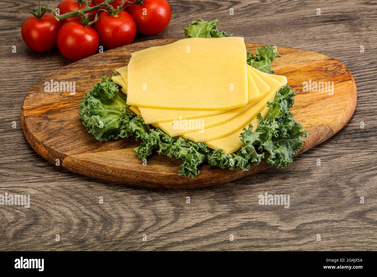Sliced Gauda cheese snack over board Stock Photo - Alamy