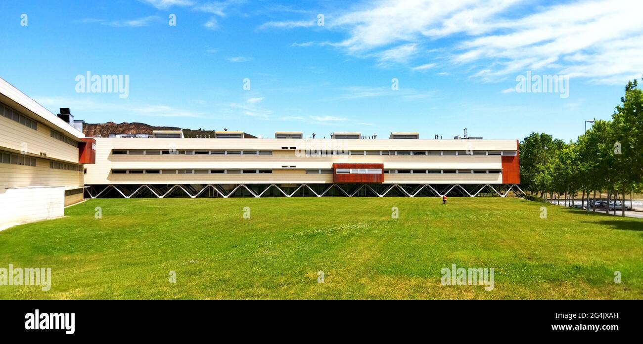 Natural view of a green lawn near a modern building under a bright sky ...