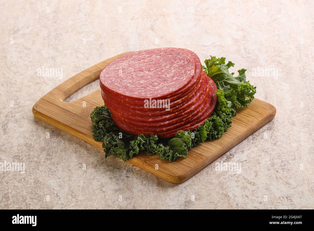 Sliced salami pork sausage snack over board Stock Photo - Alamy