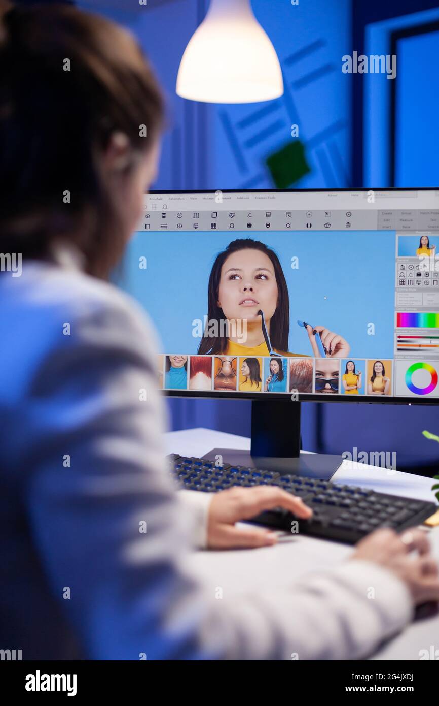 Creative creator doing portrait retouch using color grade late at night ...