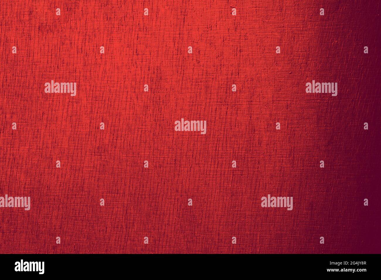 Vibrant red wall background with a wrinkled texture resembling a piece ...