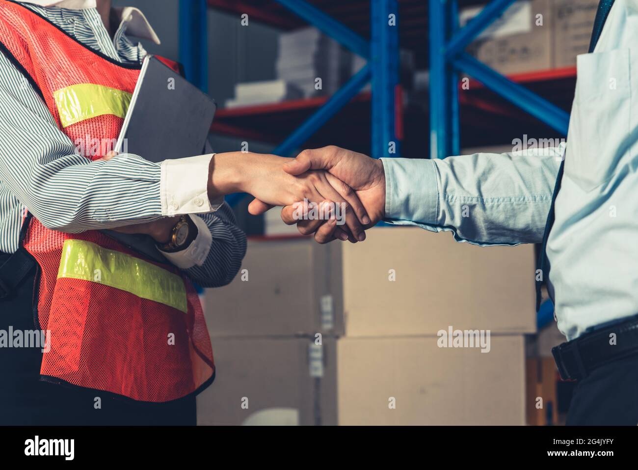 Warehouse worker handshake with manager in storehouse . Logistics ...