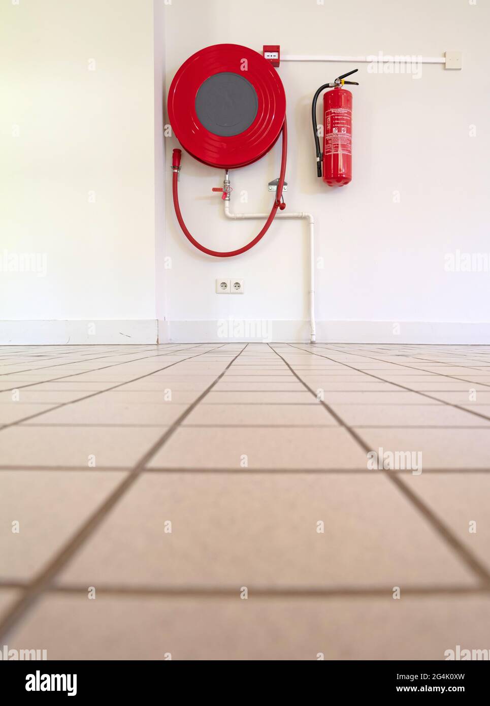 Fire hose on a wall, safety in case of a fire Stock Photo - Alamy