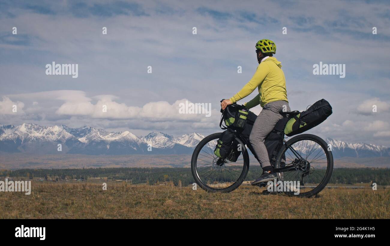 The man travel on mixed terrain cycle touring with bikepacking. The ...