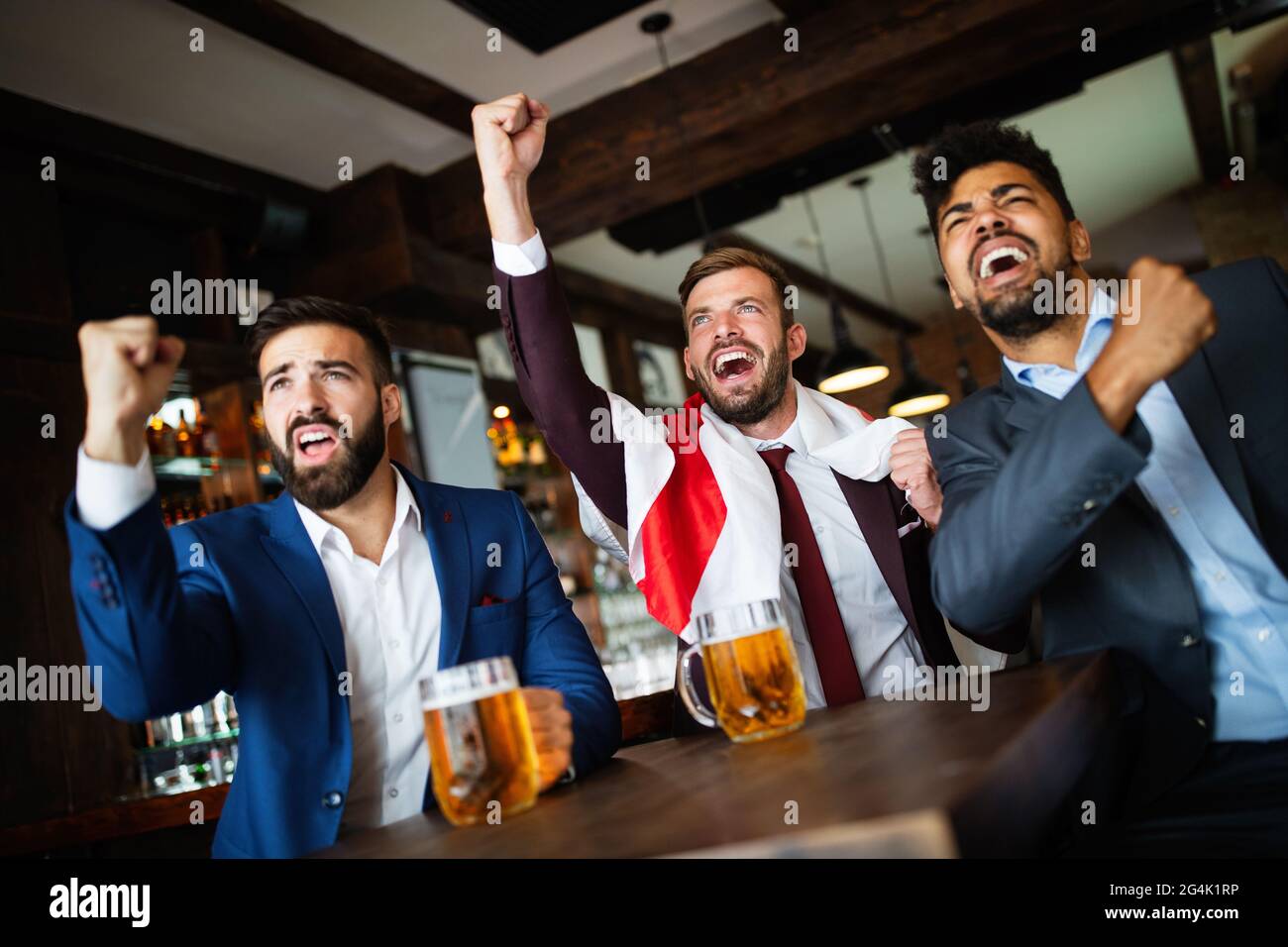 Business men in pub cheering for a sporting event Stock Photo - Alamy
