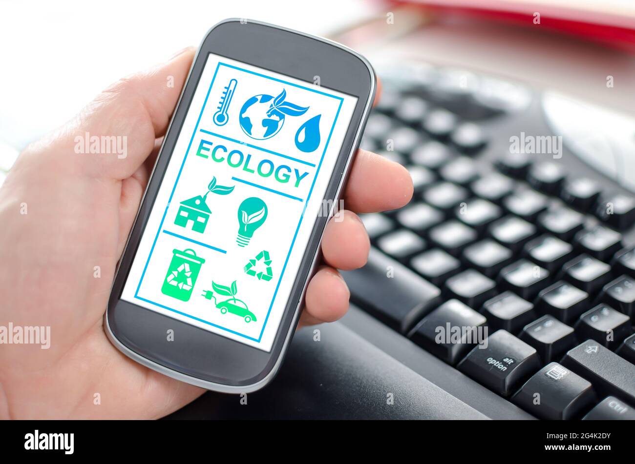 Hand holding a smartphone showing an ecology concept Stock Photo - Alamy