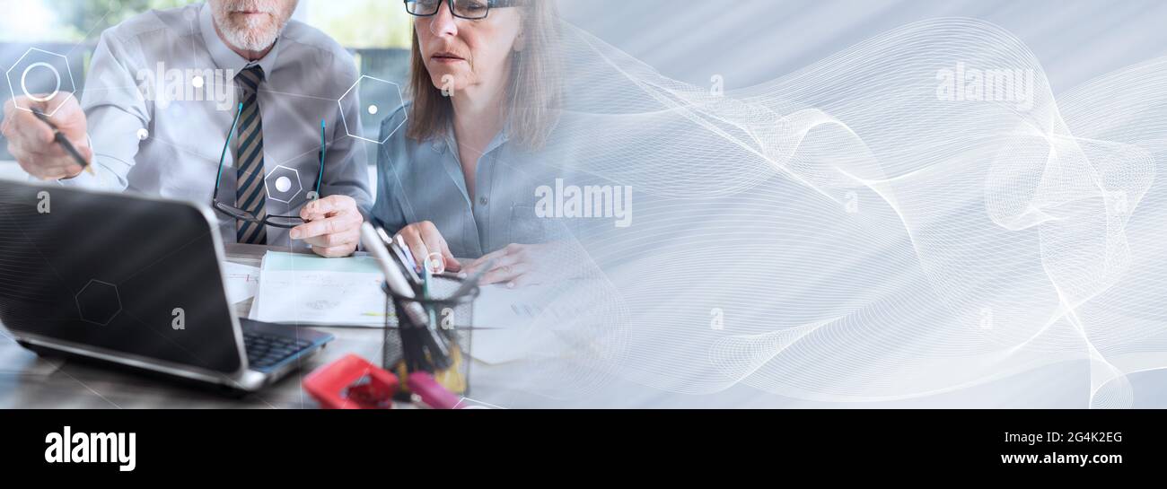 Two mature business people working together in office; panoramic banner ...