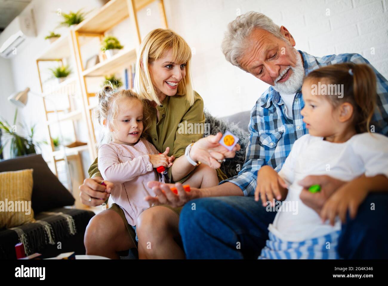 Senior grandparents playing with grandchildren and having fun with ...