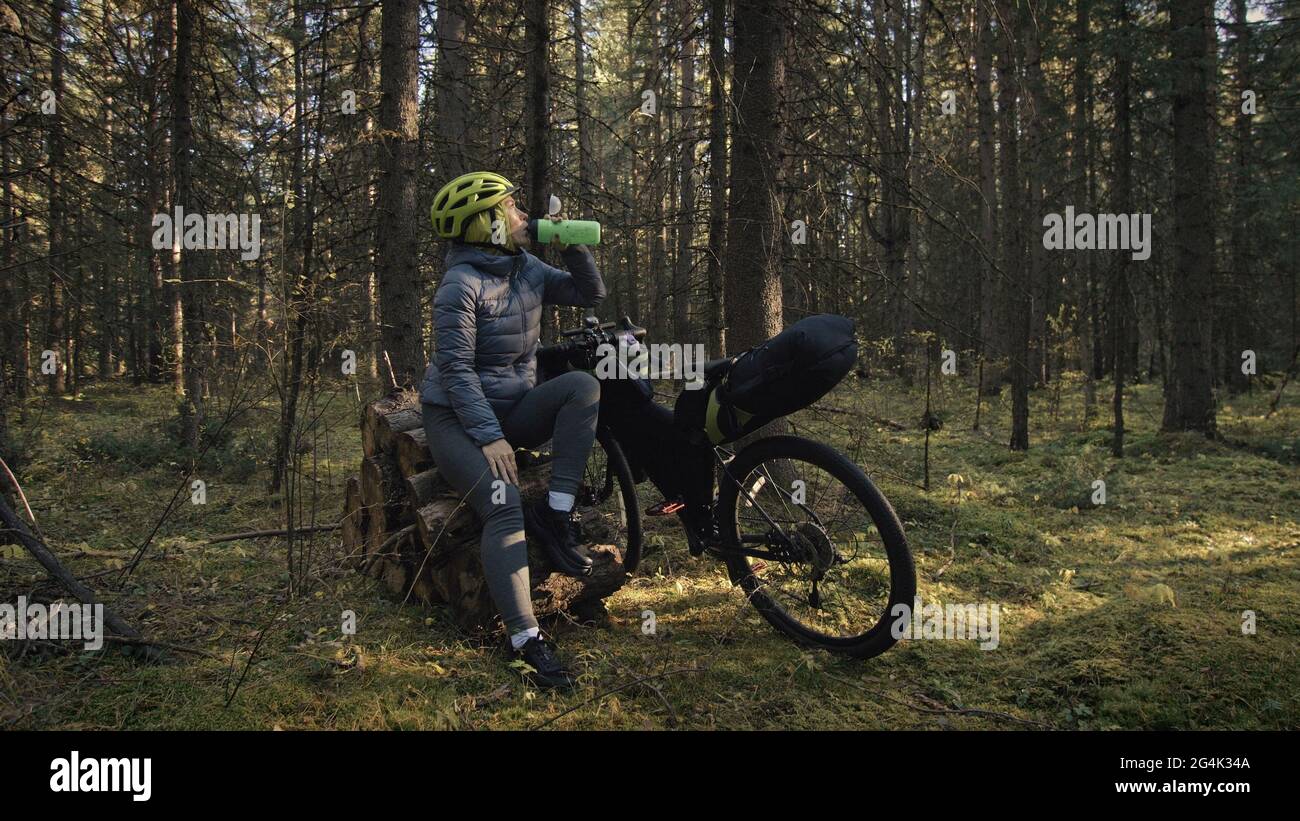 The woman travel on mixed terrain cycle touring with bike bikepacking ...