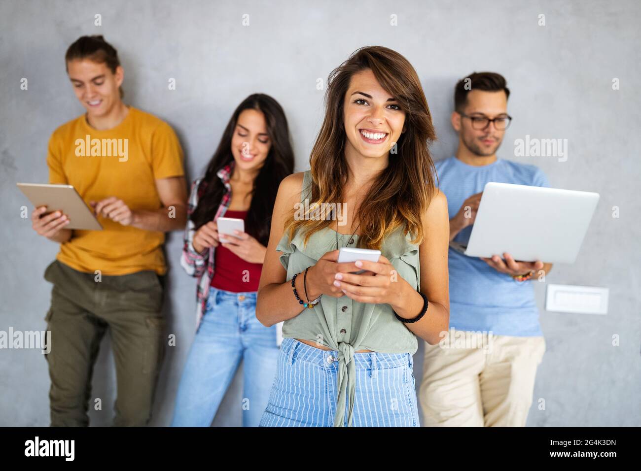 Education, technology and people concept. Happy group of friends using ...