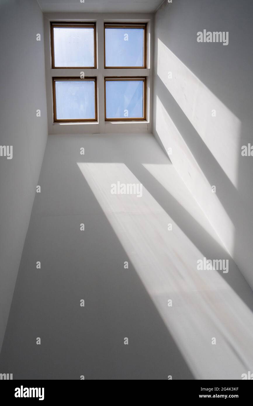 Low angle shot of sun rays falling from a high window into the house ...