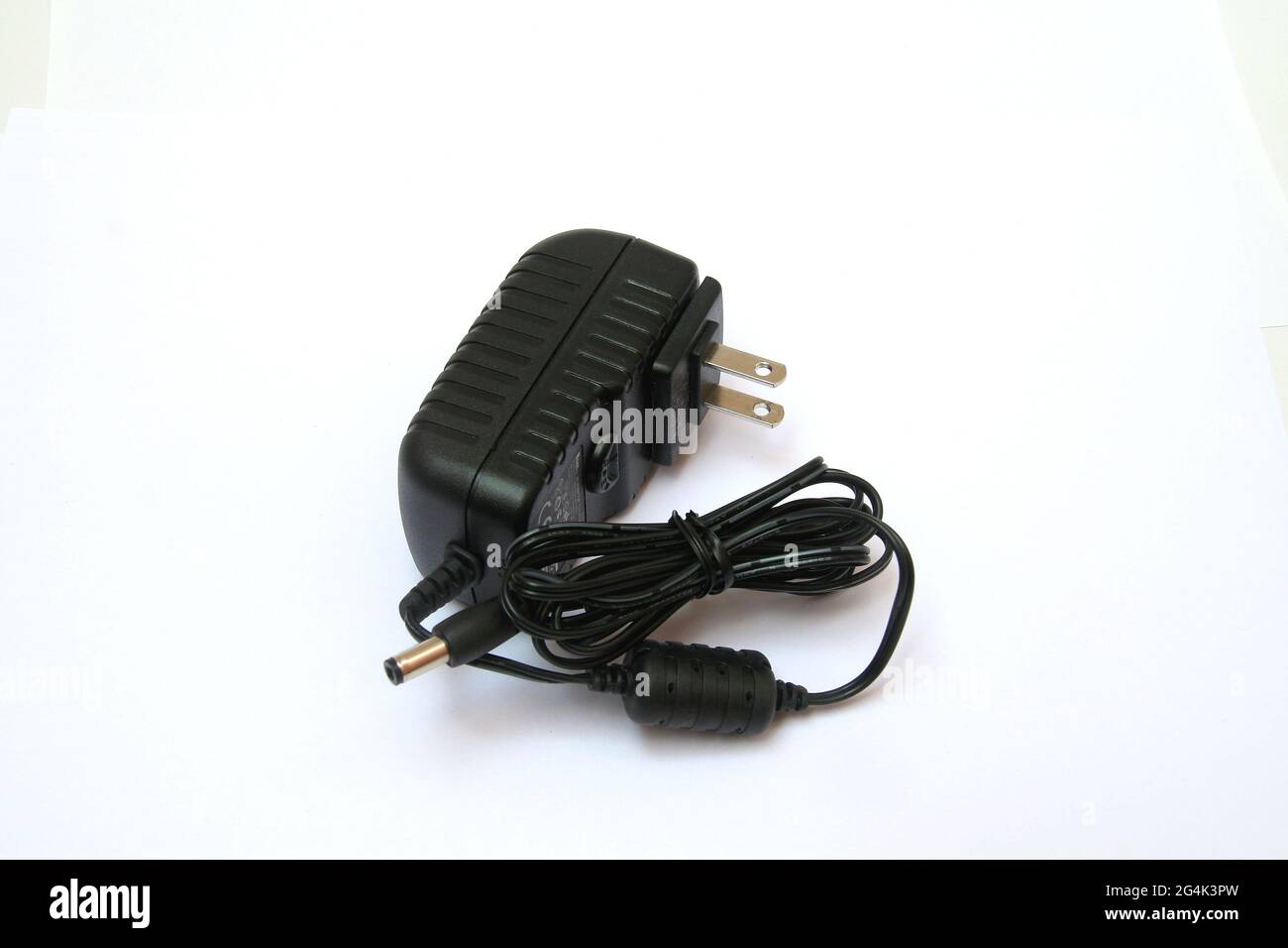 Electrical mains adapter with cable and pin isolated on a white ...