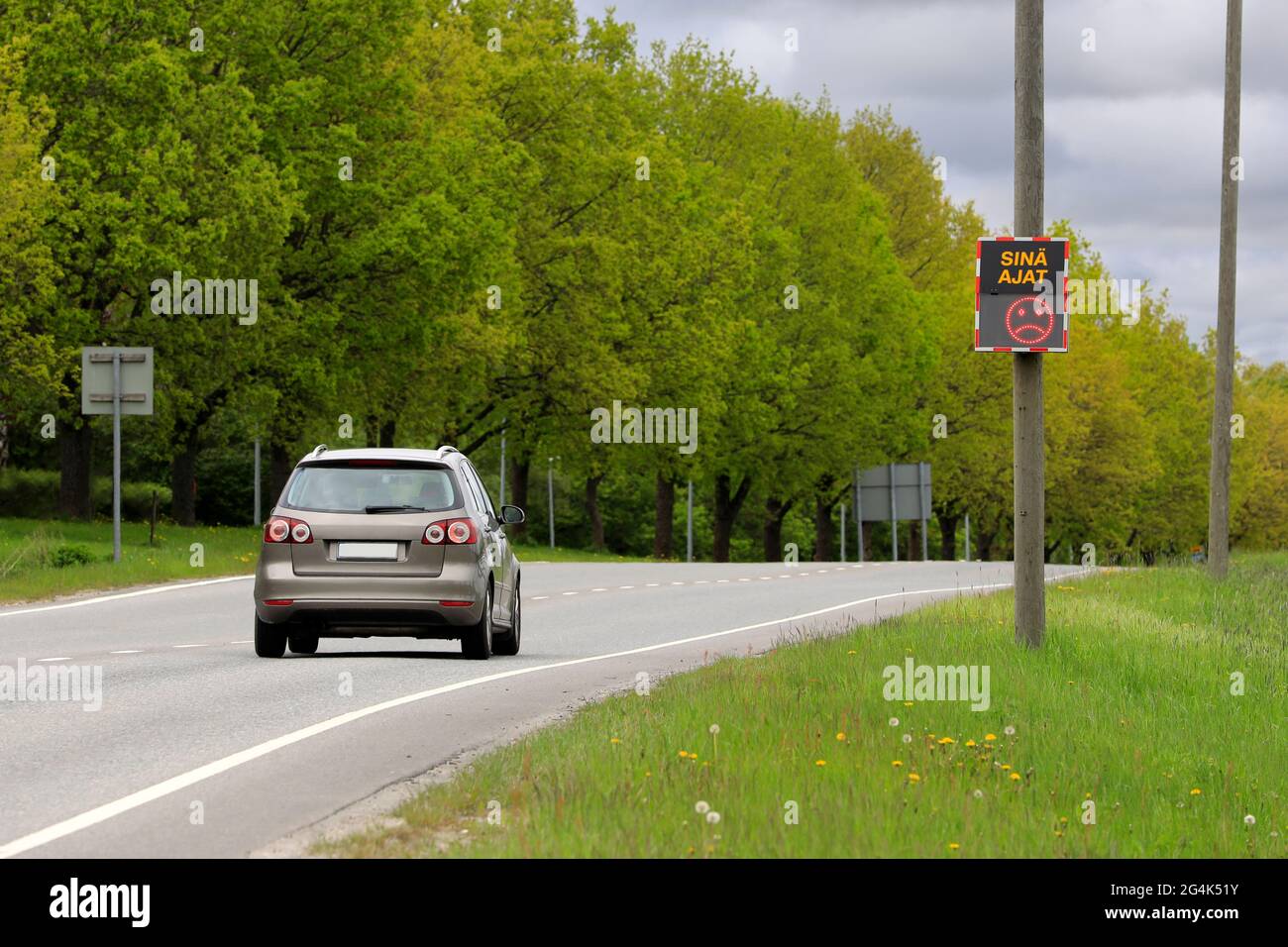 Speed monitoring device showing a sad red face to a driver who is ...