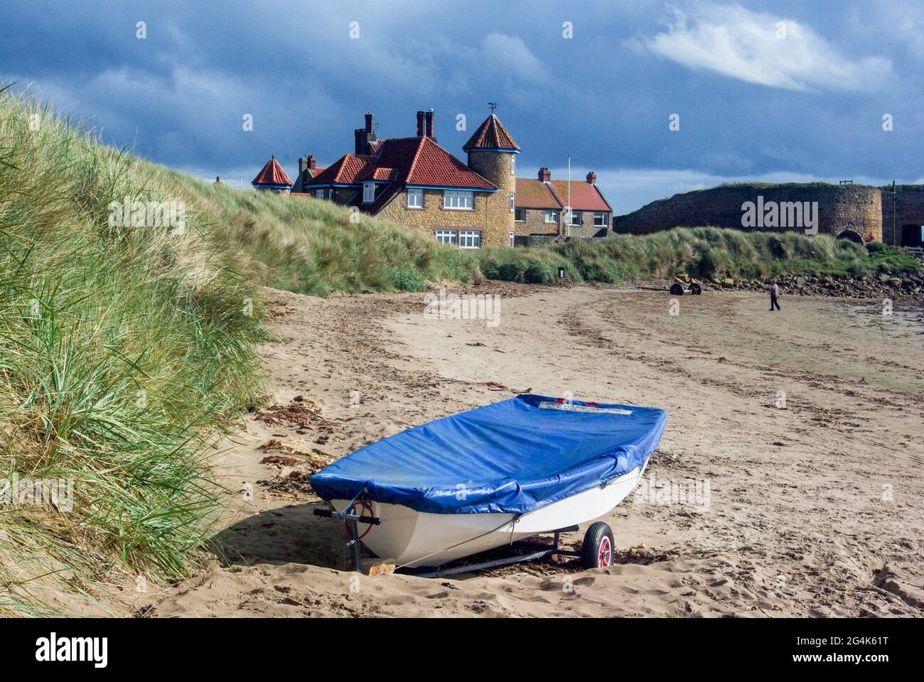 Beadnell Harbour, Beadnell, Northumberland, UK; boat with a blue cover ...