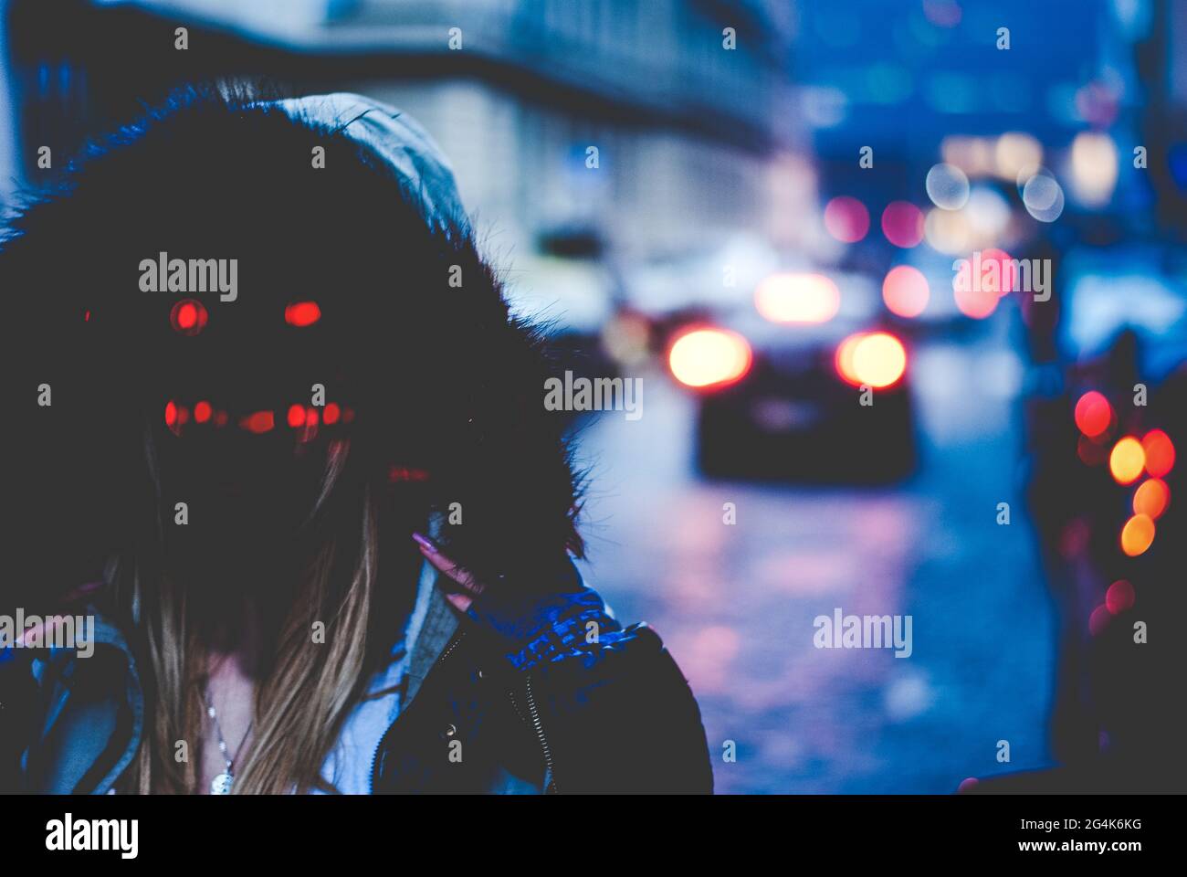 Closeup of a girl walking on the street wearing a scary mask with ...