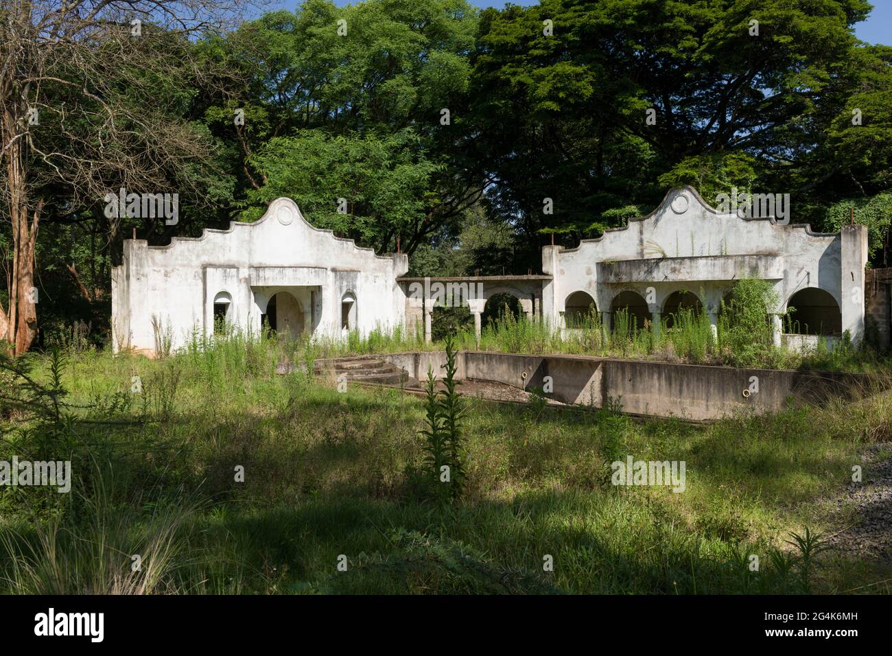 An abandoned swimming pool of an old colonial house on land at corner ...