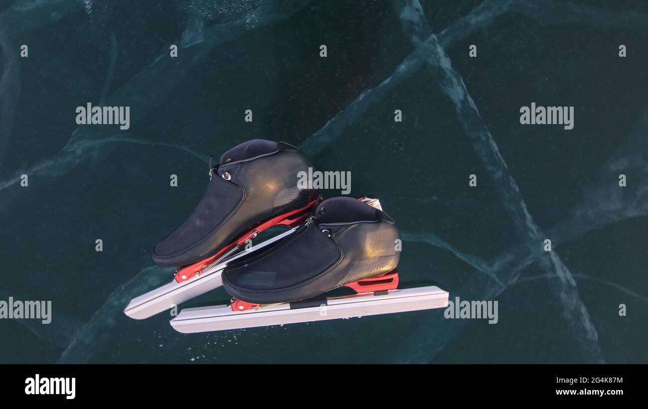The skates are on the ice. The child train on ice speed skating. The ...